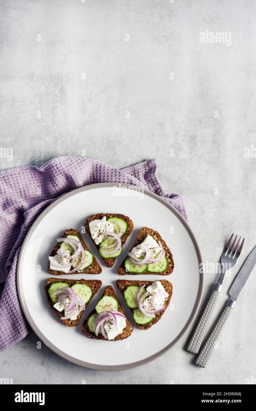 Canapes with toasted bread with sunflower and flax seeds, feta cheese ...