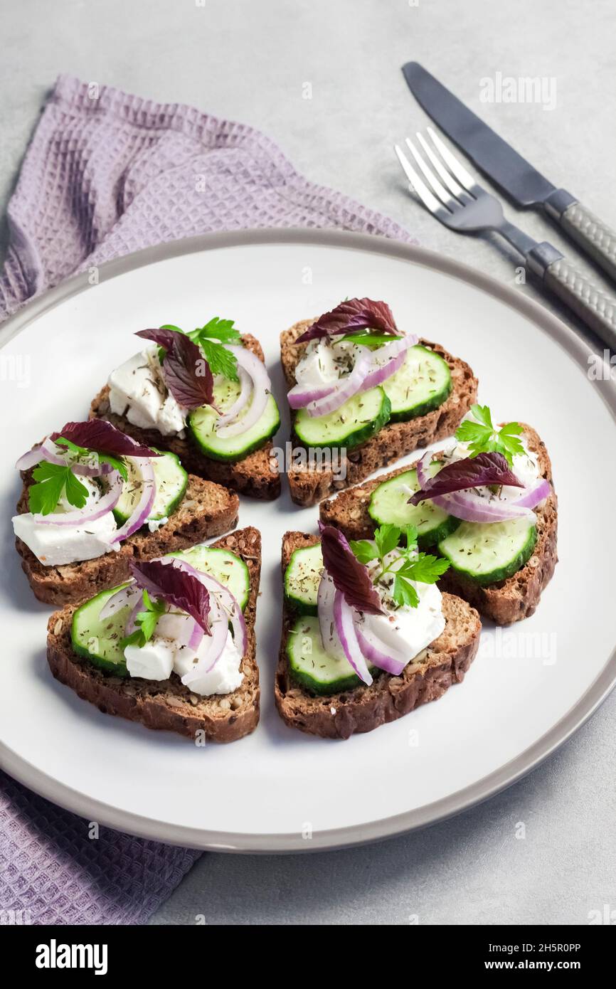 Canapes with toasted bread with sunflower and flax seeds, feta cheese ...