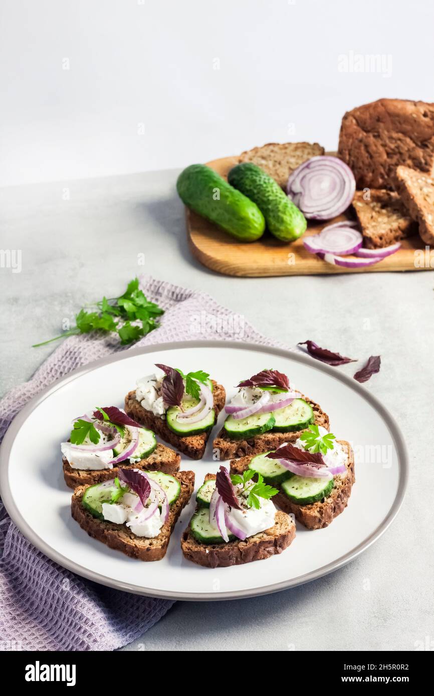 Canapes with toasted bread with sunflower and flax seeds, feta cheese ...