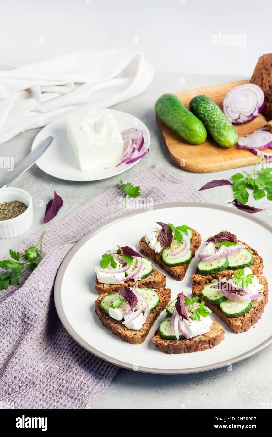 Canapes with toasted bread with sunflower and flax seeds, feta cheese ...