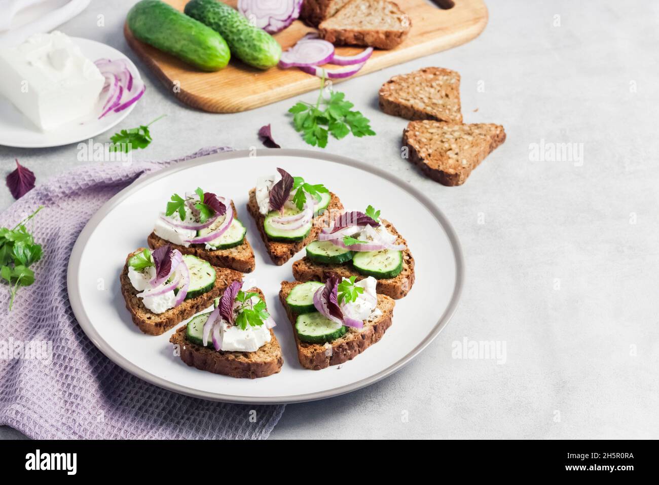 Canapes with toasted bread with sunflower and flax seeds, feta cheese ...