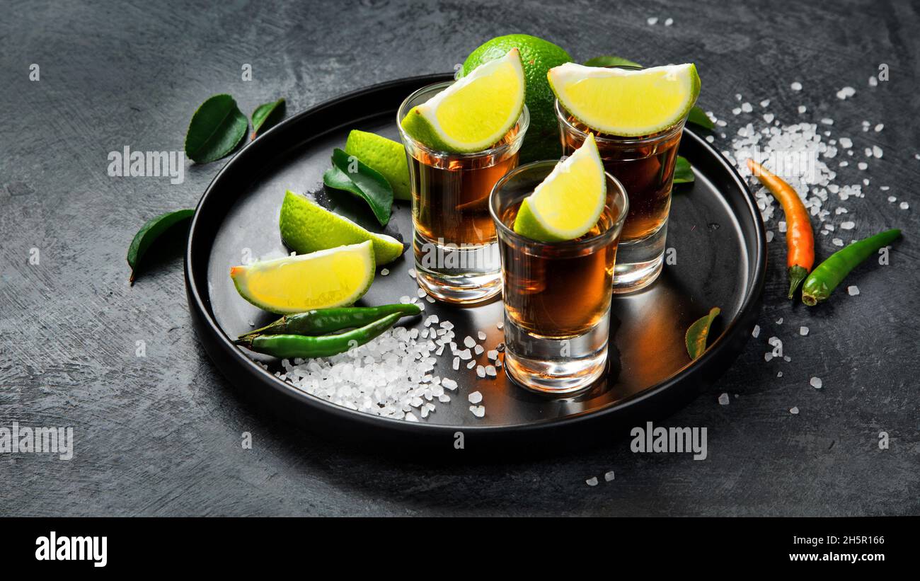 Tequila shots with lime and salt on gray background. Classic bar menu ...