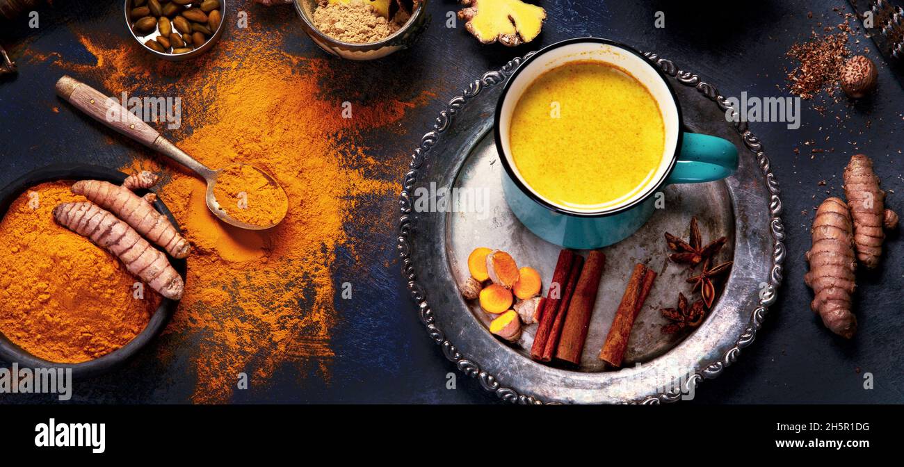 Healthy turmeric golden milk on dark background. Indian traditional ...