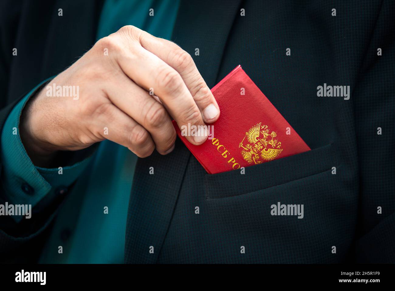 The Red identity card of FSB. Man With Id Card. Man in a blue suit ...