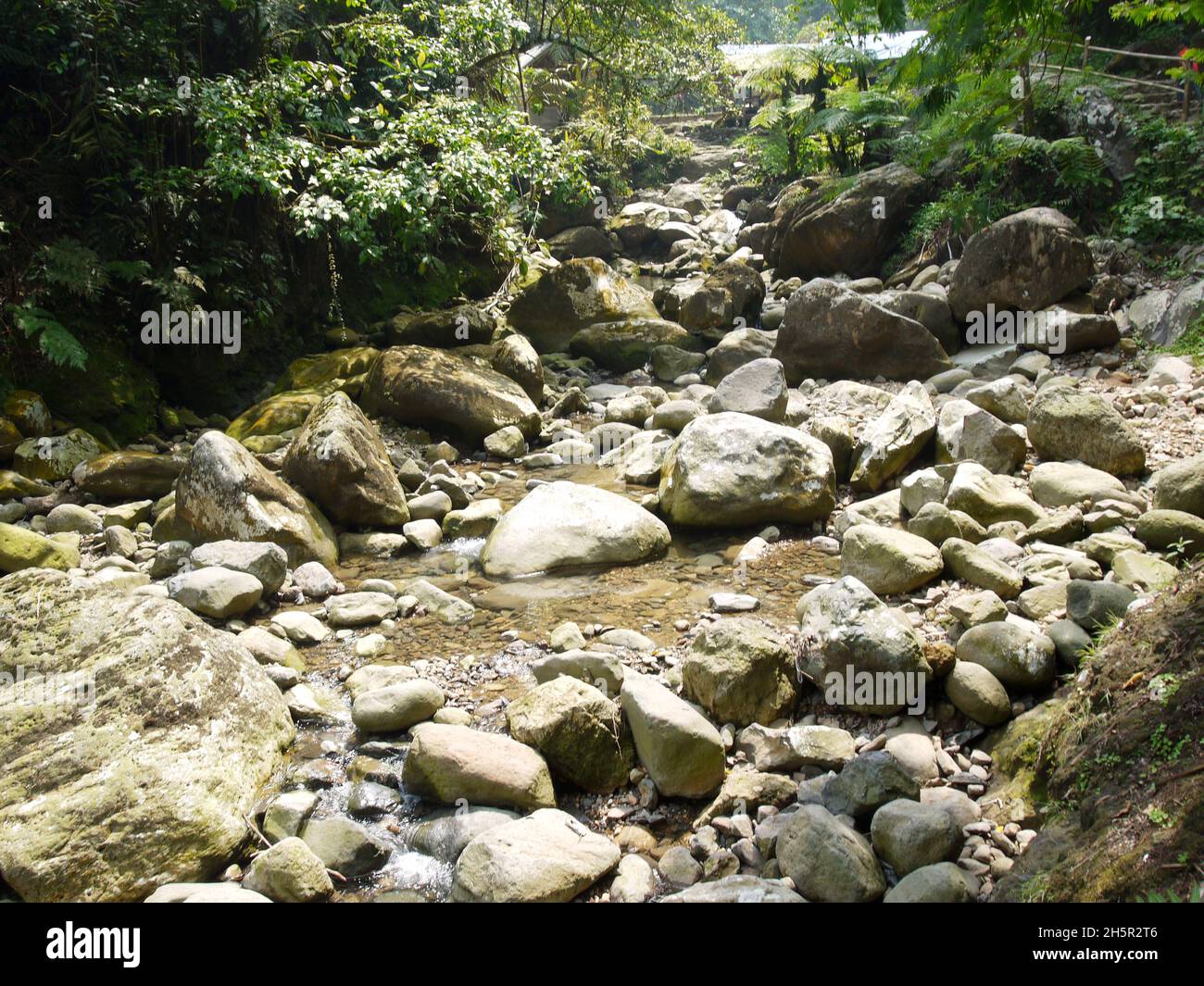 view of a river with lots of big rocks Stock Photo - Alamy