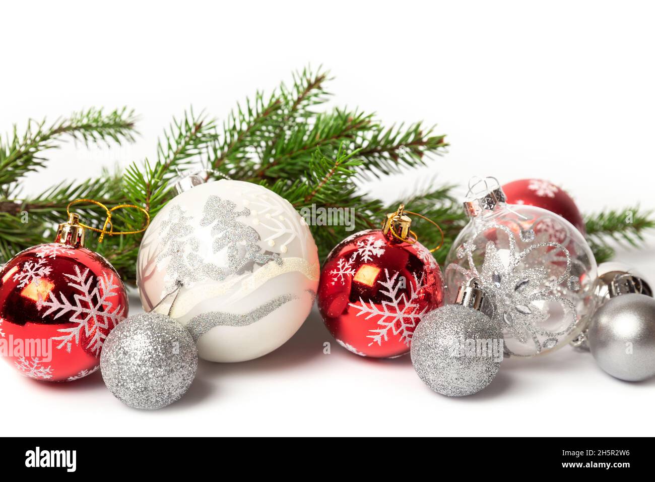 White and red Christmas decorations baubles and spruce branch on white ...