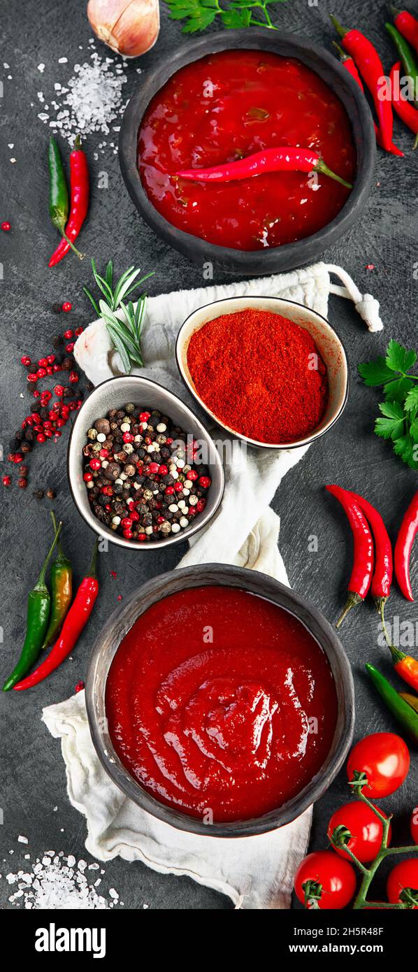Spicy hot chilli tomato sauce on gray background. Traditional hot sauce ...