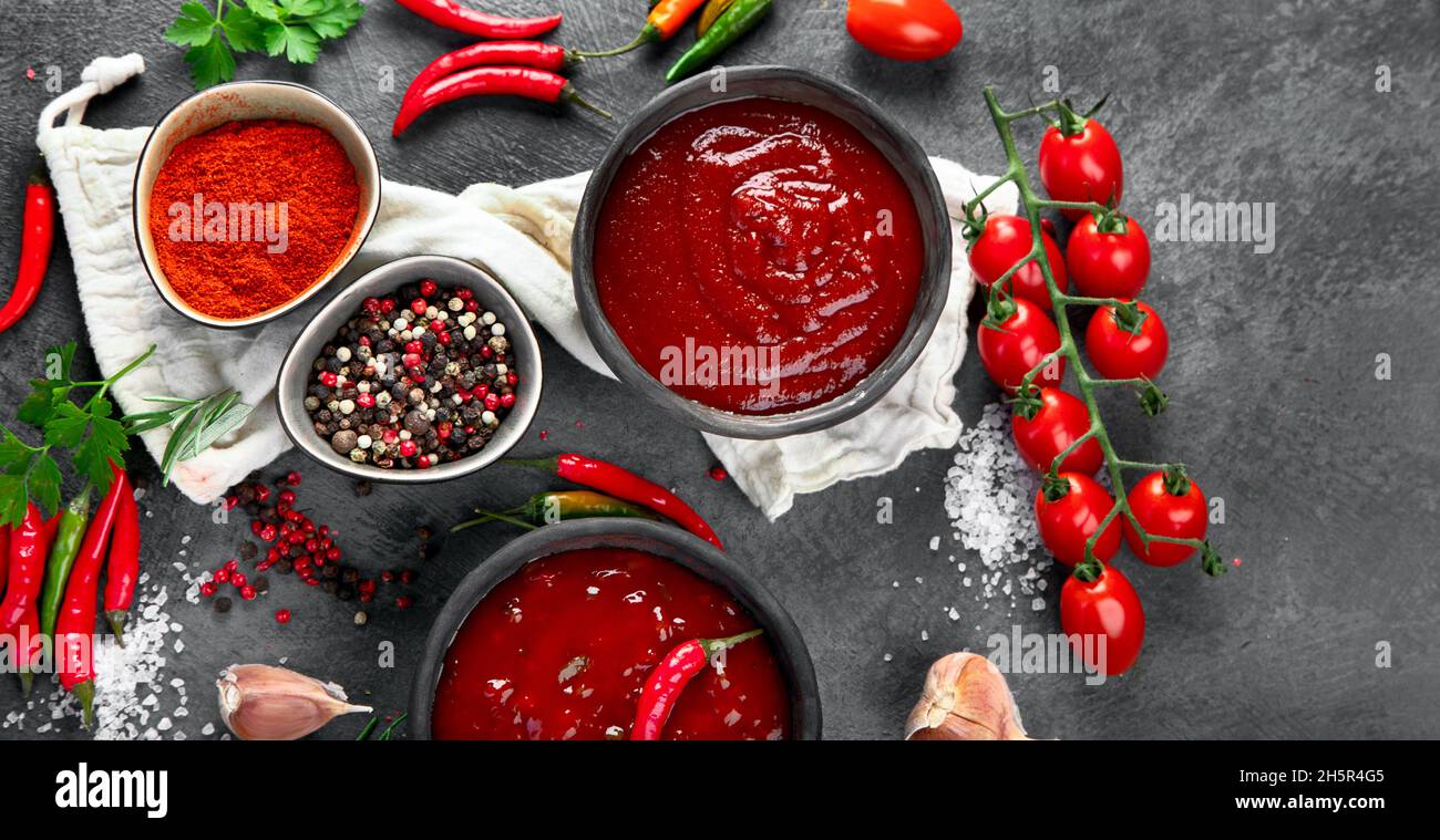 Spicy hot chilli tomato sauce on gray background. Traditional hot sauce ...