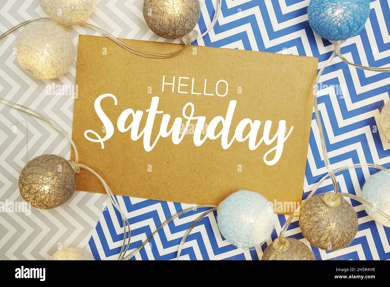 Hello Saturday typography text on paper card with LED cotton balls ...