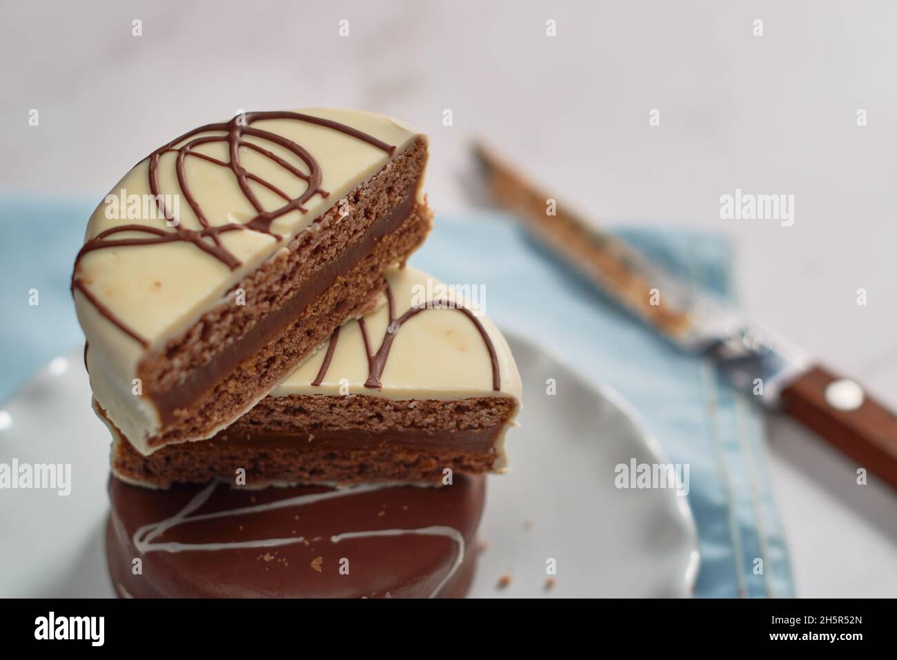 Argentinian chocolate alfajores filled with dulce de leche stacked on ...