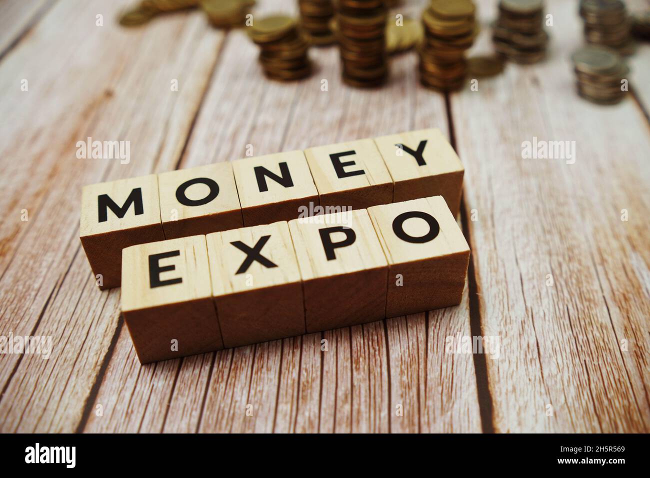 Money Expo alphabet letter and coins on wooden background Stock Photo ...