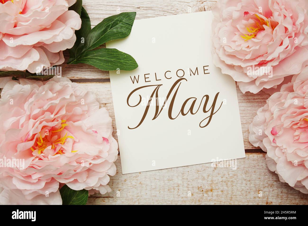 Welcome May card typography text with flower bouquet on wooden ...
