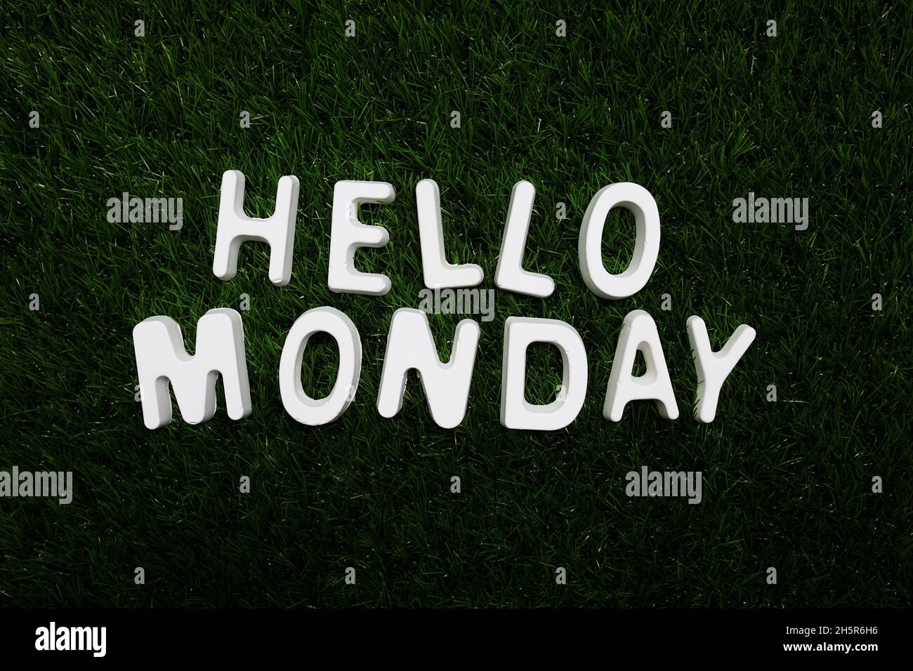 Hello Monday alphabet letter on green grass background Stock Photo - Alamy