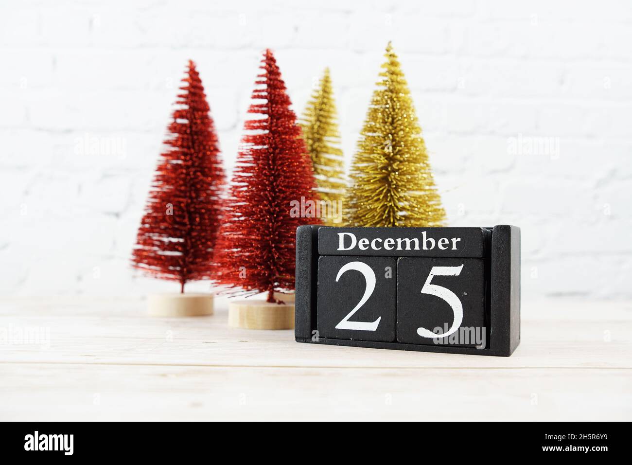 December 25th on the wooden calendar with little christmas tree on ...