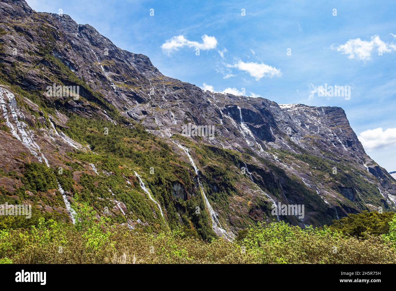 Small waterfalls from sheer cliffs on the way to Fiordland. South ...