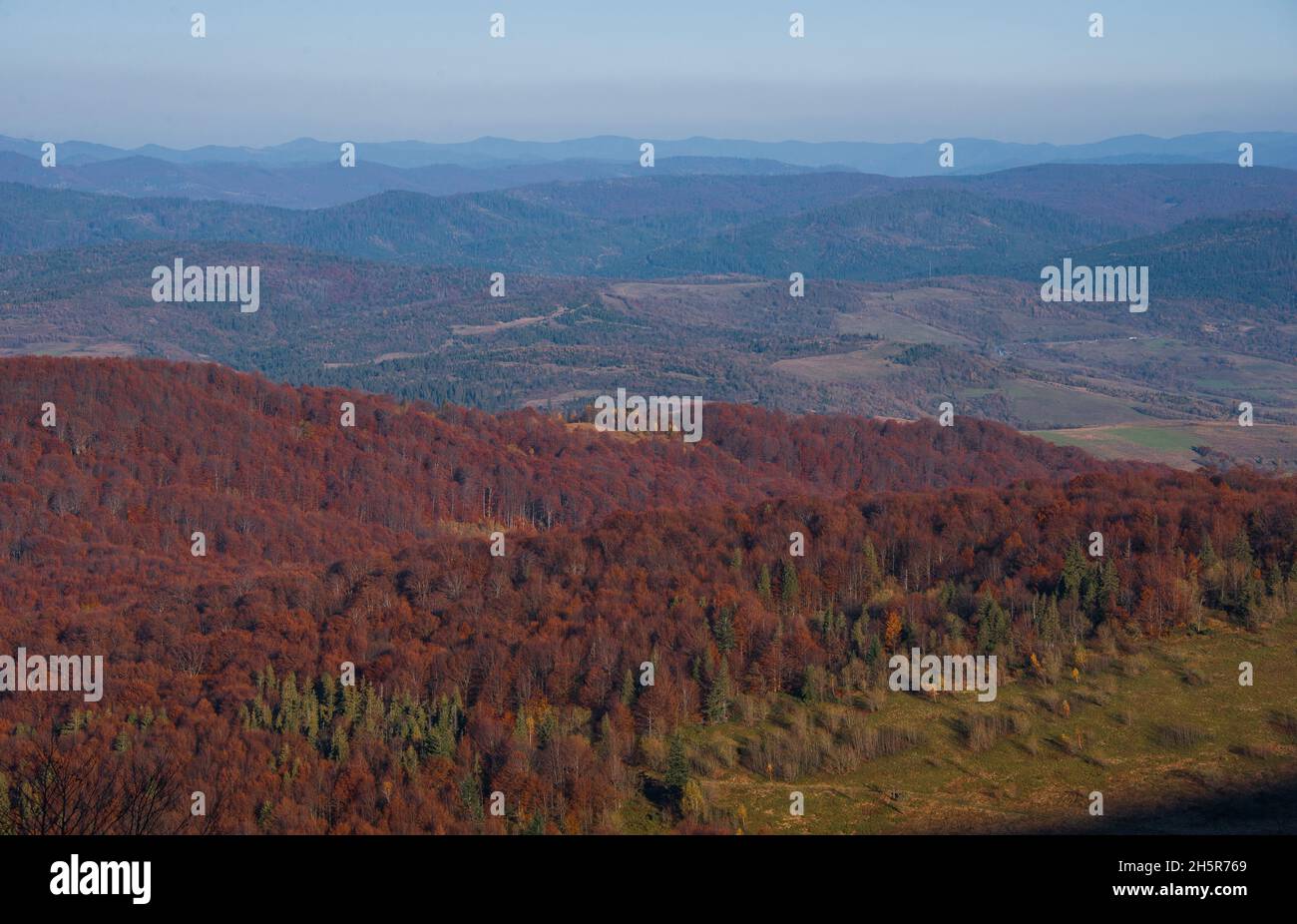 View of hills of Water Dividing ridge covered in red, orange and yellow ...