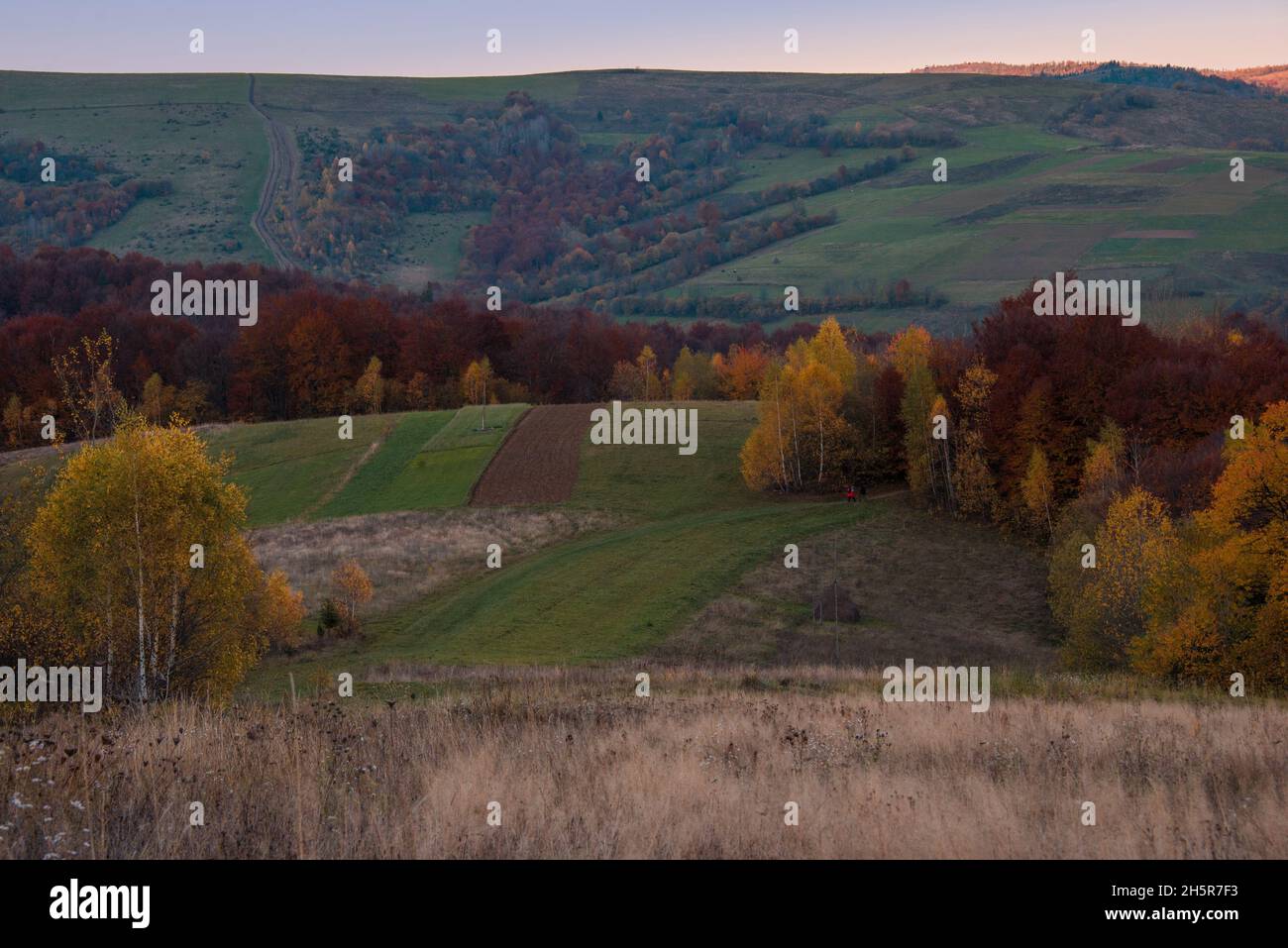 View of hills of Water Dividing ridge covered in red, orange and yellow ...