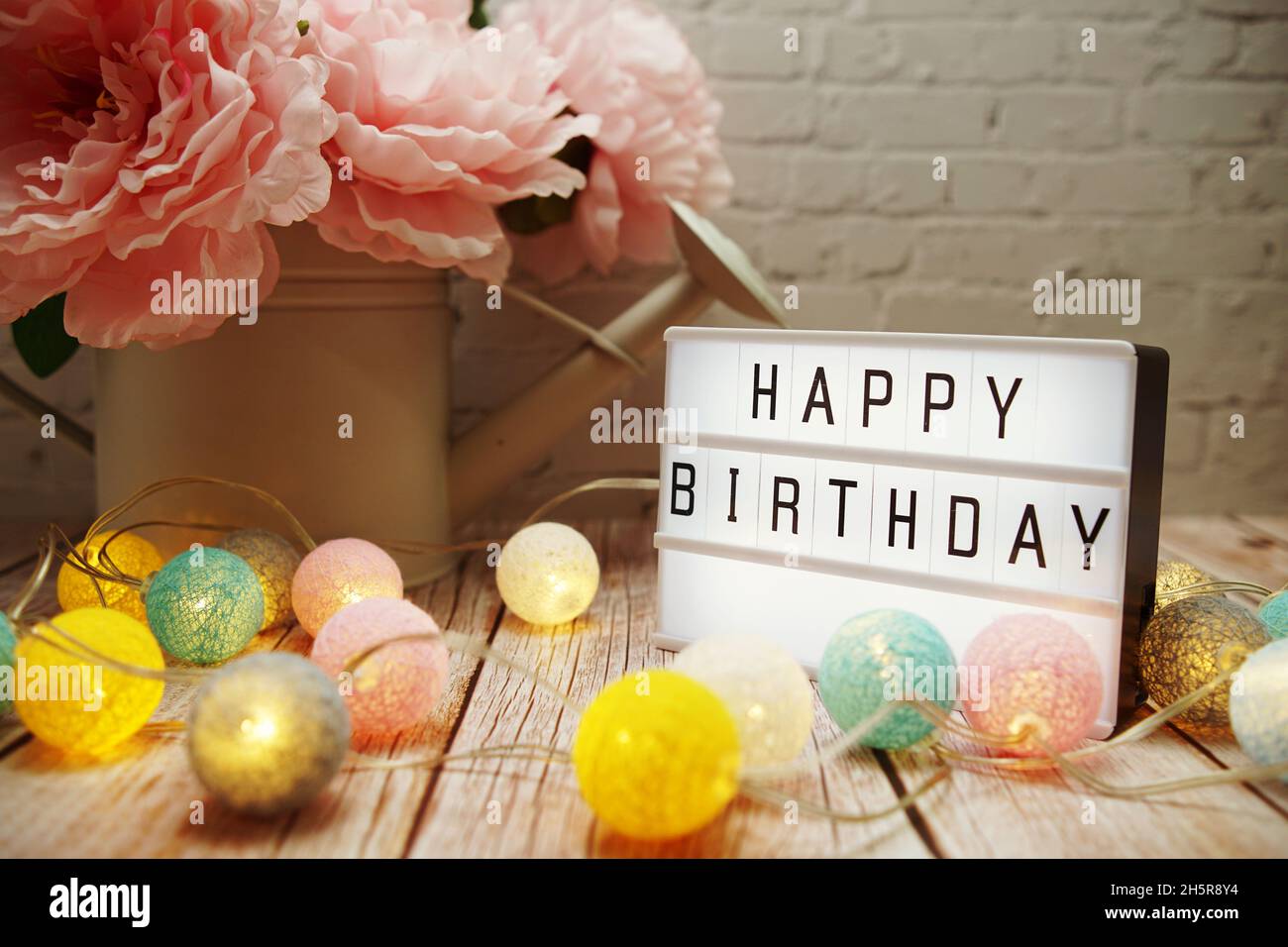 Happy Birthday text on lightbox on wooden background Stock Photo - Alamy