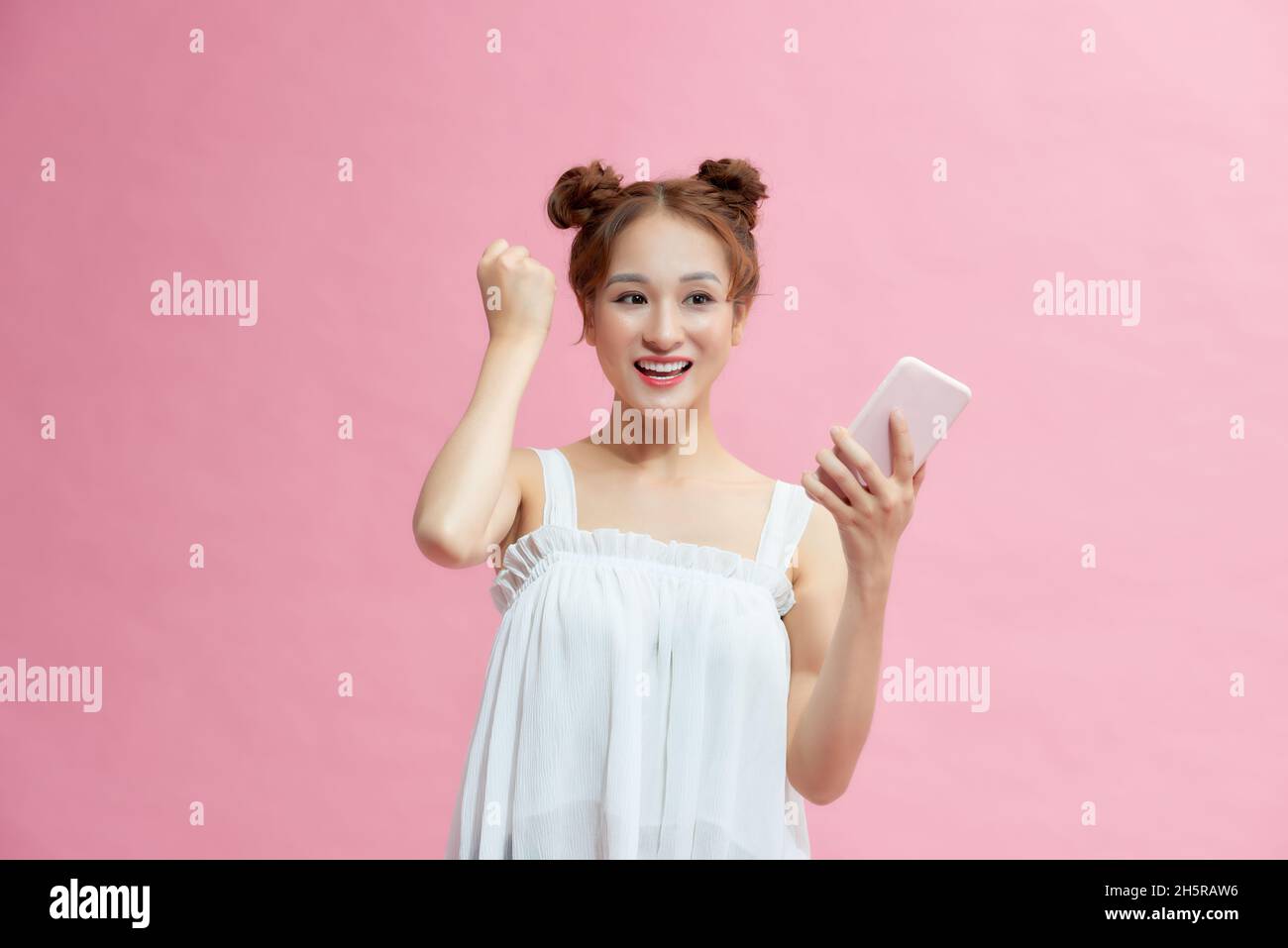 Successful woman is raising fist to celebrate a victory, winner concept ...