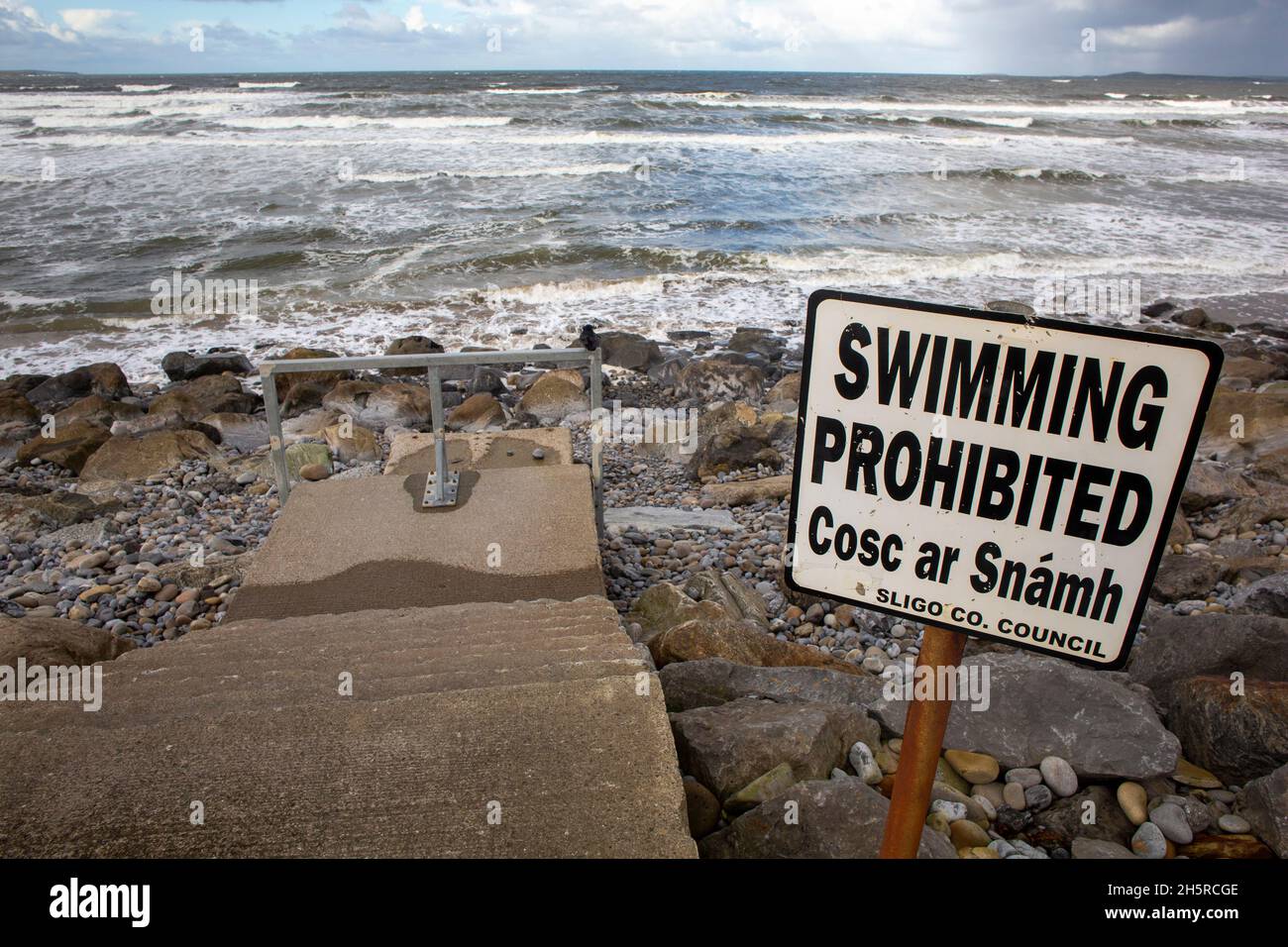 A bilingual sign at the beach n Strandhill, Sligo. Irish and English ...