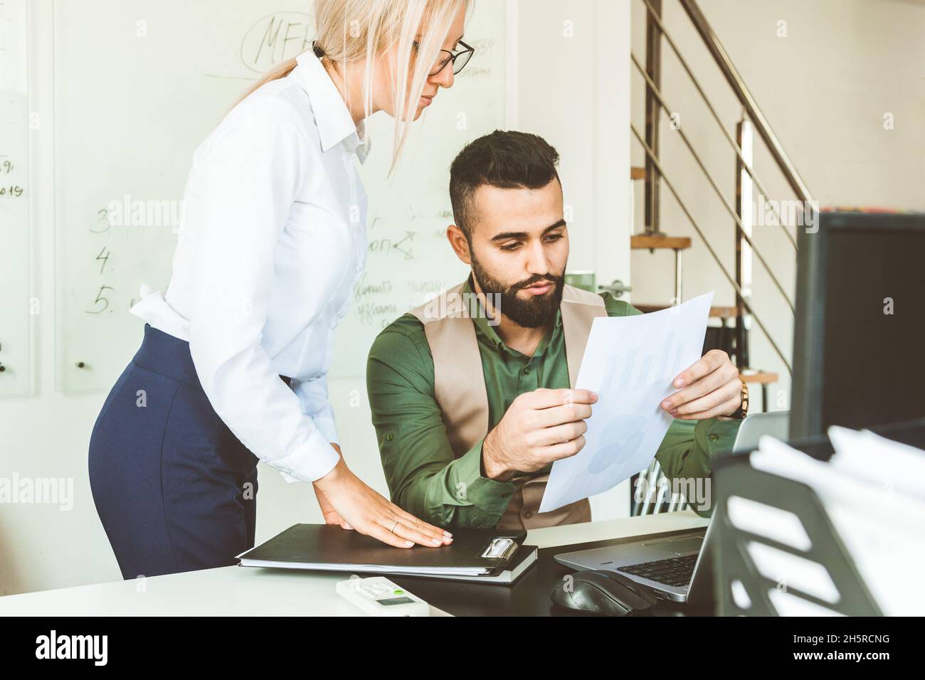 Secretary and Chief signs papers. A team of young businessmen working ...