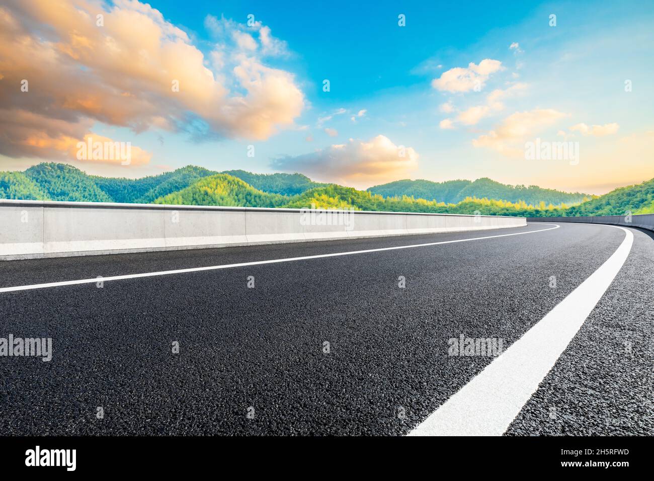 Country asphalt road and green tea plantation with bamboo forest ...