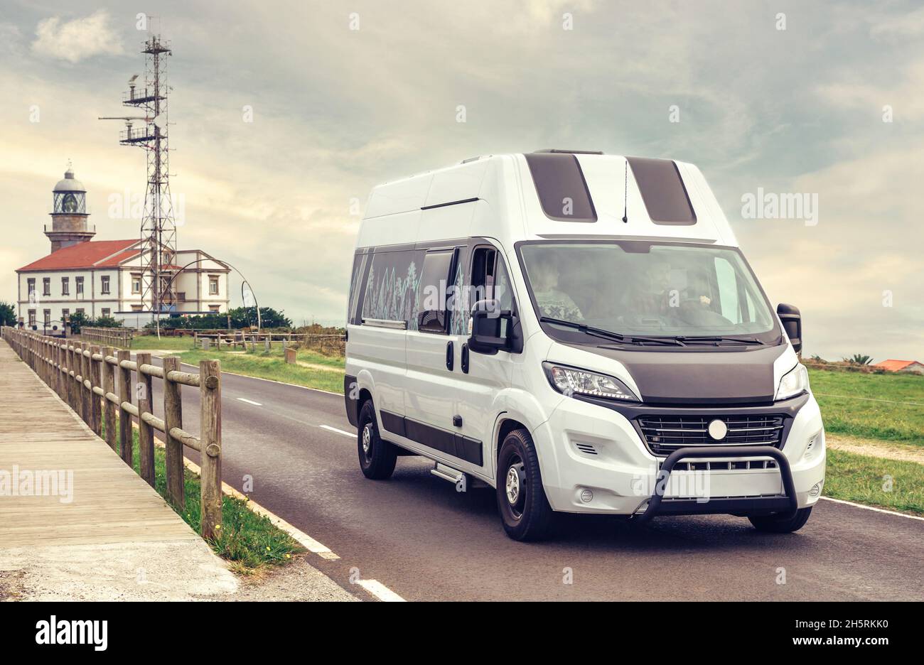 Camper van traveling near to a lighthouse Stock Photo - Alamy
