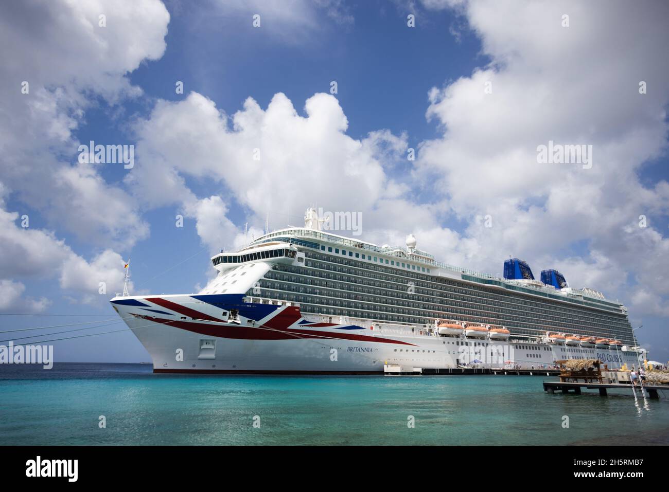 Cruise liner. Cruise ship staying in a harbour with turquoise colour ...