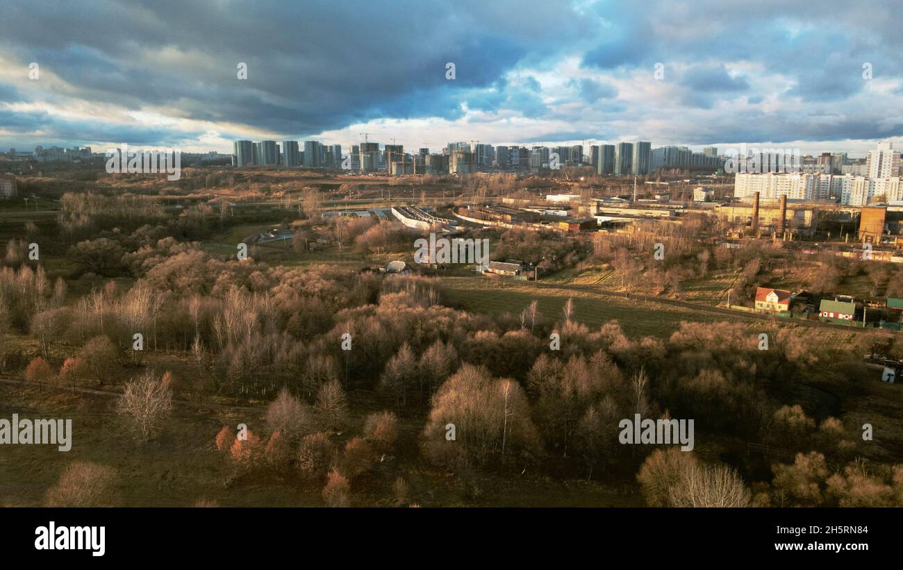 Flight over city blocks. Multi-storey buildings and construction site ...