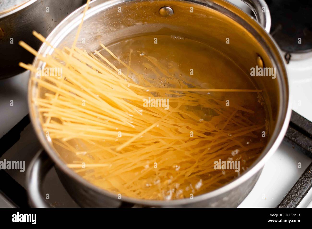 Spaghetti is boiled in water. Cooking Italian pasta at home Stock Photo ...