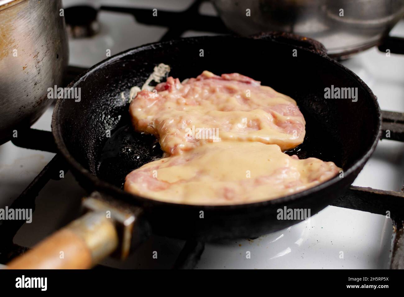 Meat chop in batter is fried in a pan. Cooking meat food Stock Photo ...