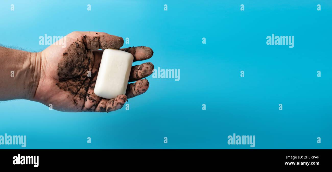 Global Handwashing Day, personal hygiene concept. Dirty hand holds soap ...