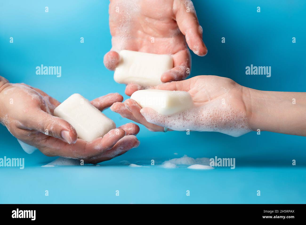 Global Handwashing Day, personal hygiene concept. Three hands in soapy ...
