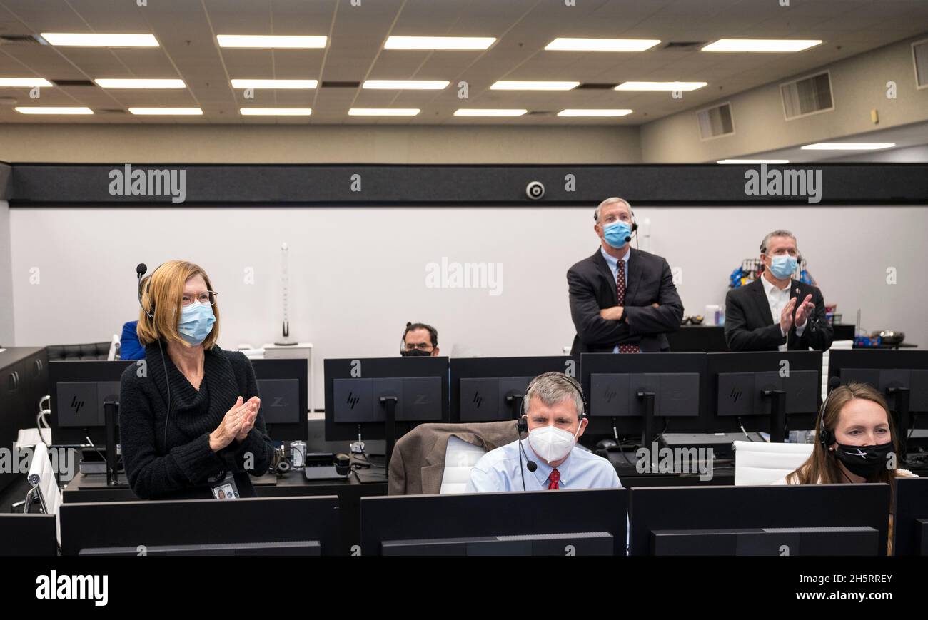 NASA and SpaceX officials clap during the launch of a SpaceX Falcon 9 ...