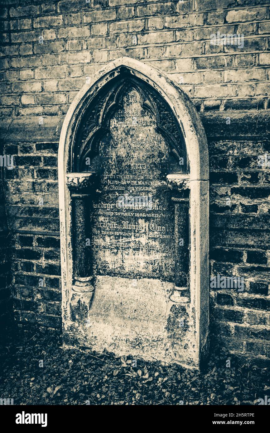 Eerie looking gravestone in a mono split tone Stock Photo - Alamy
