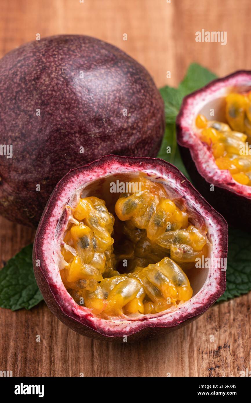 Close up of delicious juicy fresh passion fruit on wooden table background Stock Photo - Alamy