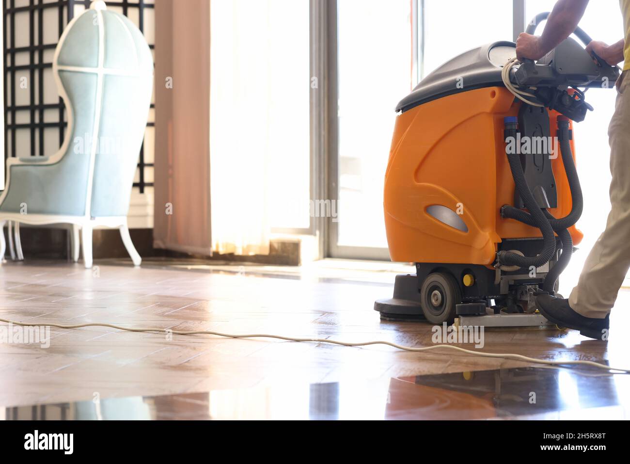 Cleaner washing floor in hotel using special machine closeup Stock ...