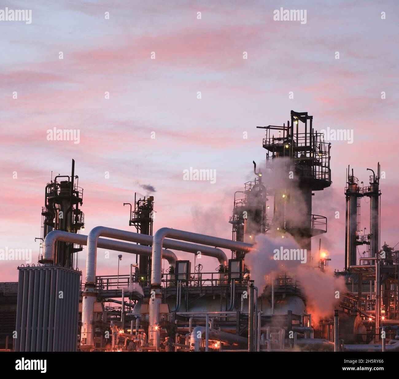 View of oil refinery piping and towers Stock Photo - Alamy