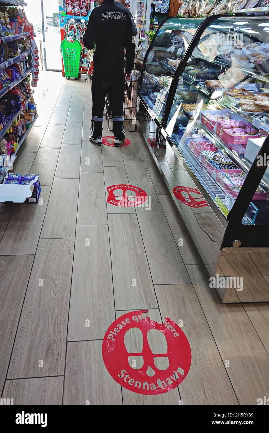 People in market are standing in line observing social distance ...