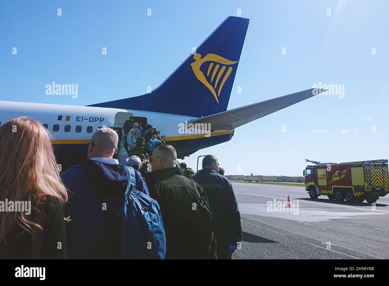 Crowd of people boarding an airplane in airport Stock Photo - Alamy