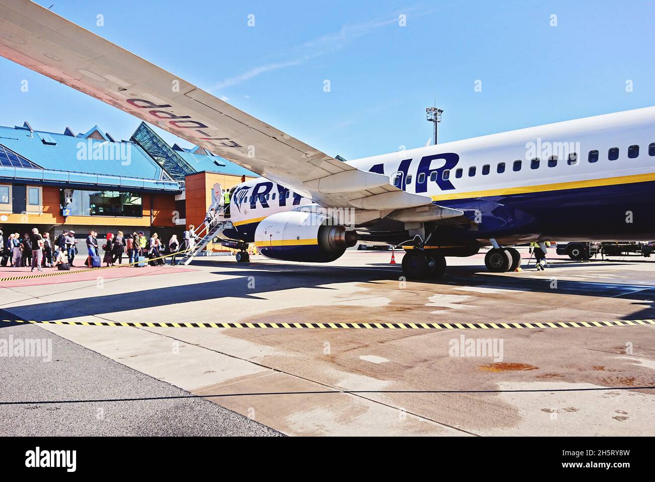 Crowd of people boarding an airplane in airport Stock Photo - Alamy