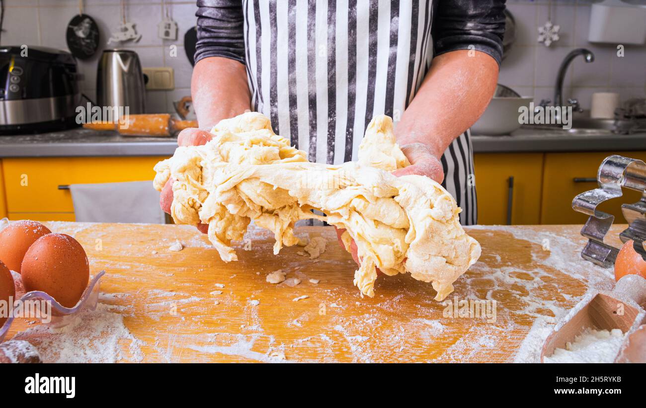 Bad dough. Inexperienced unskillful woman cook in an apron holds ...