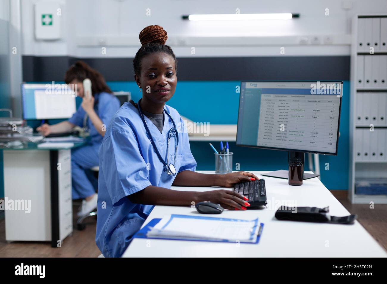 Portrait of african american pharmacist nurse typing medical ...