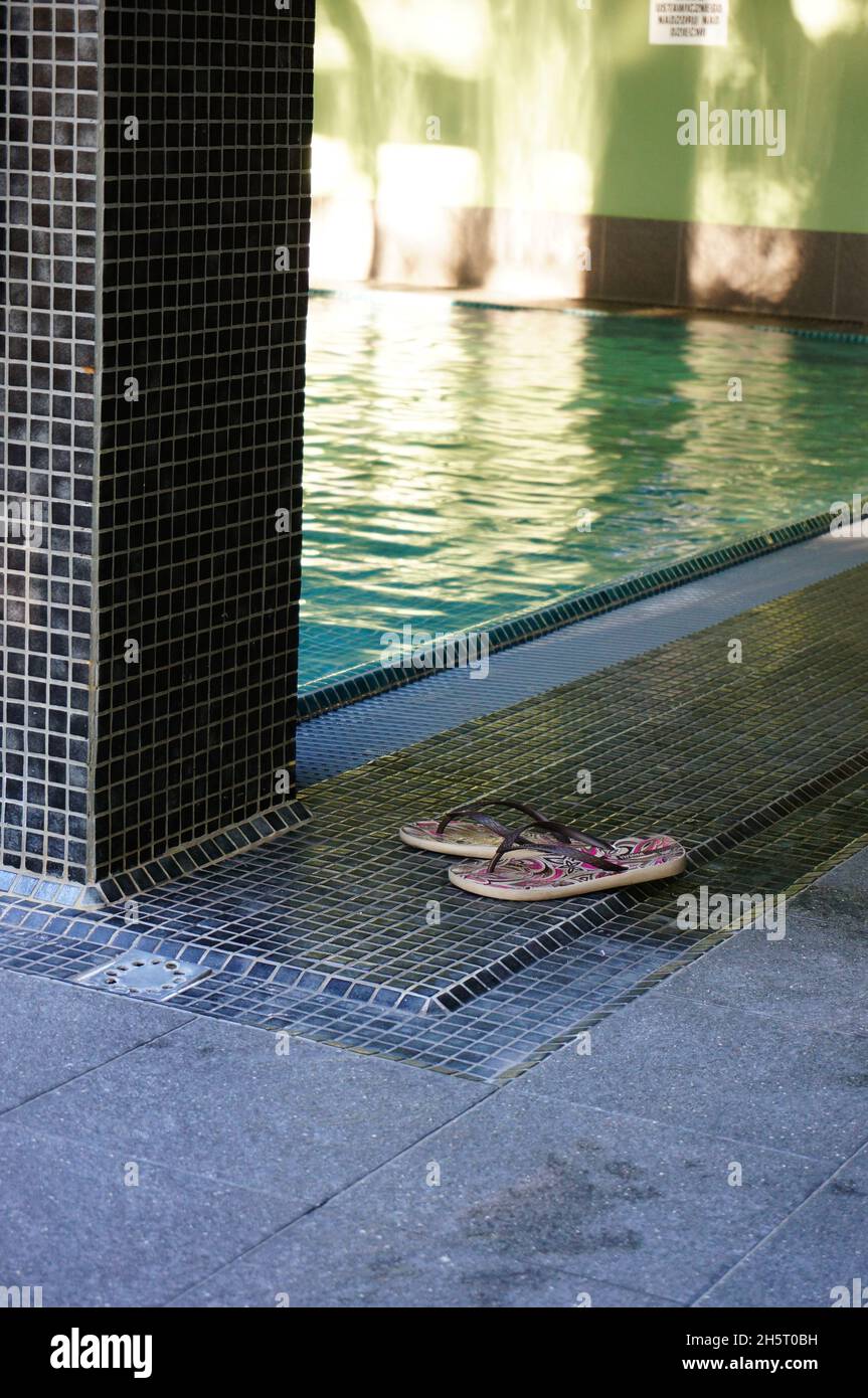 Pair of slippers next to the swimming pool Stock Photo - Alamy