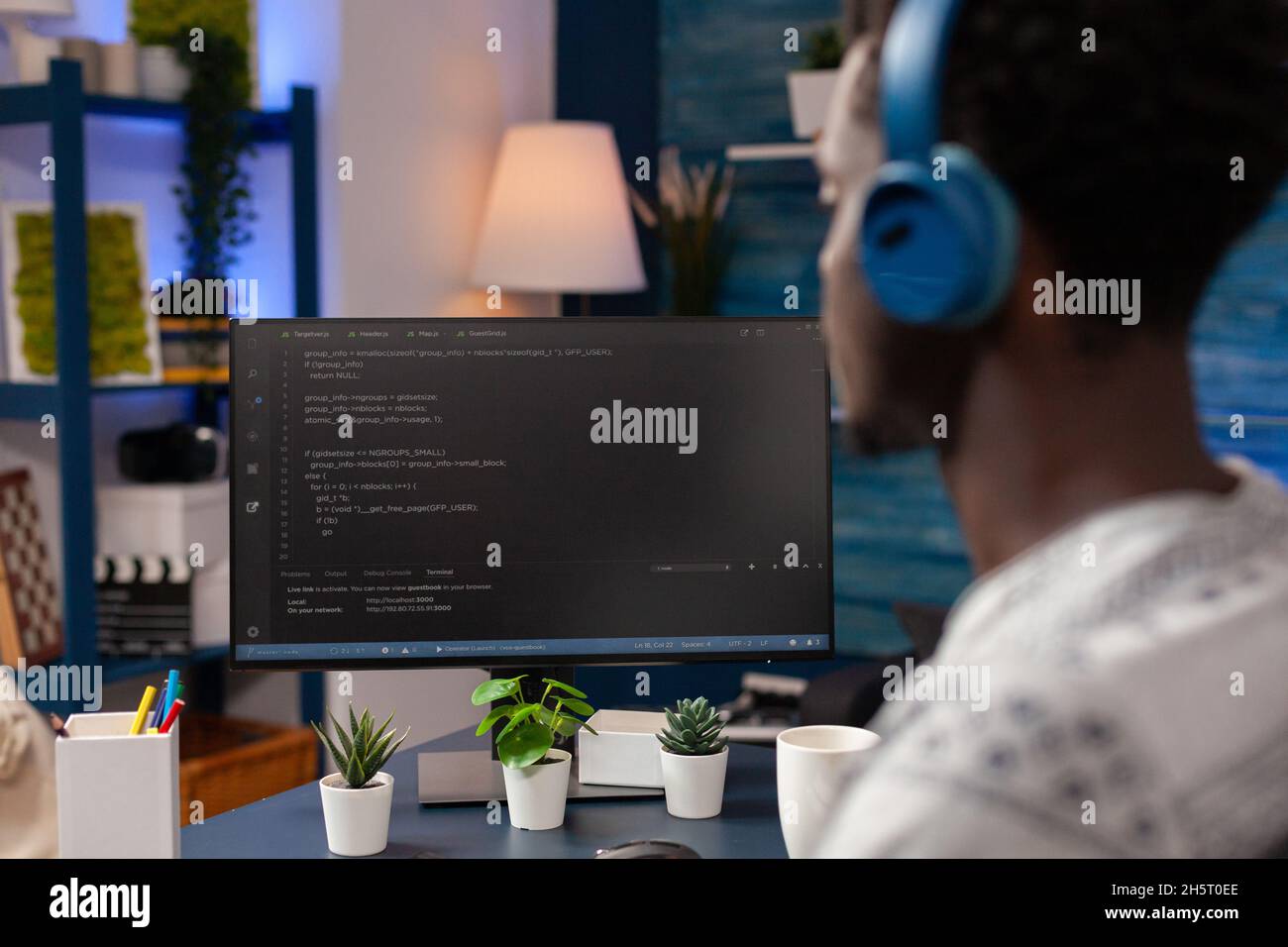 African american young developer wearing headset while typing security ...