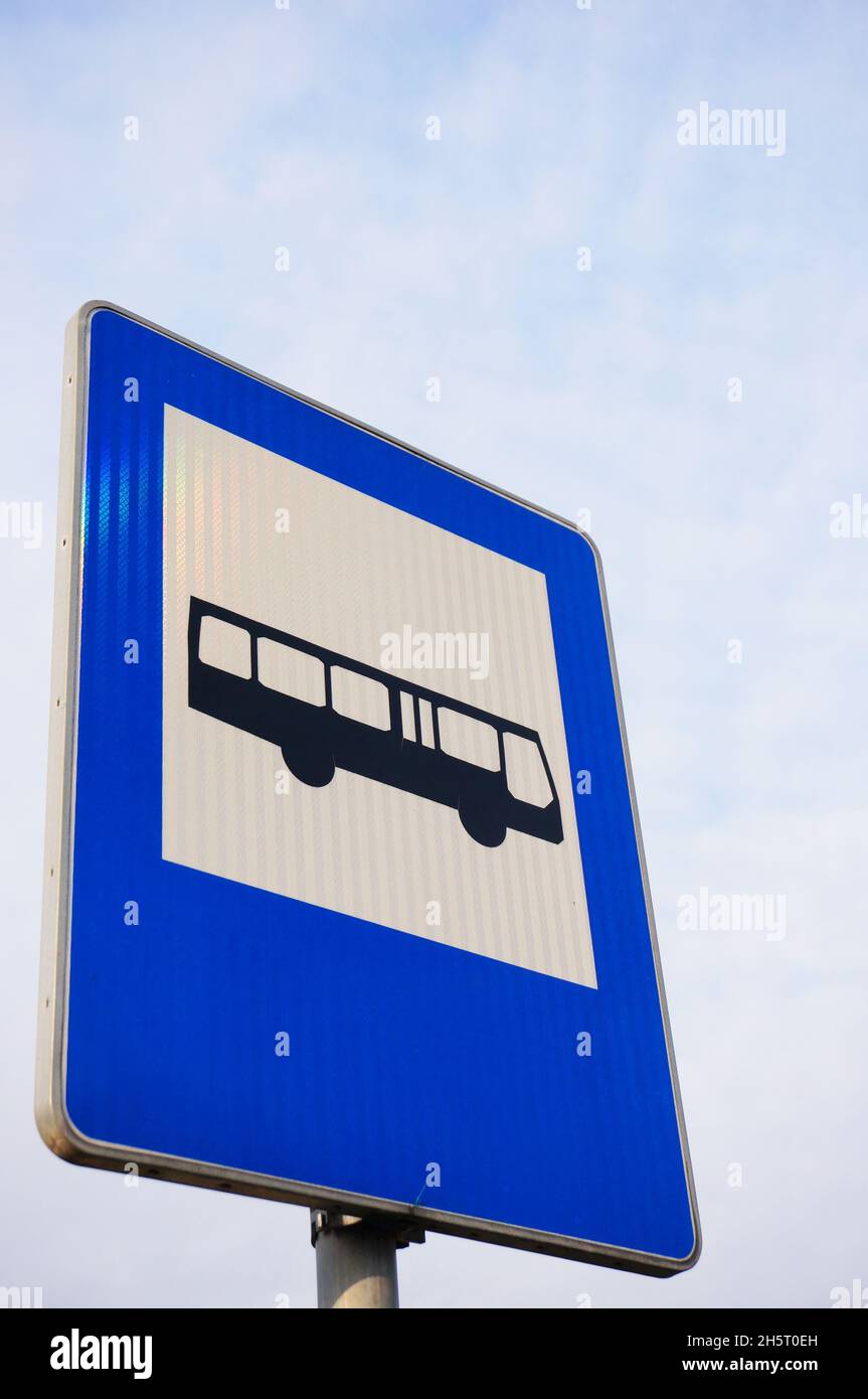 Vertical low angle of a blue bus stop sign Stock Photo - Alamy