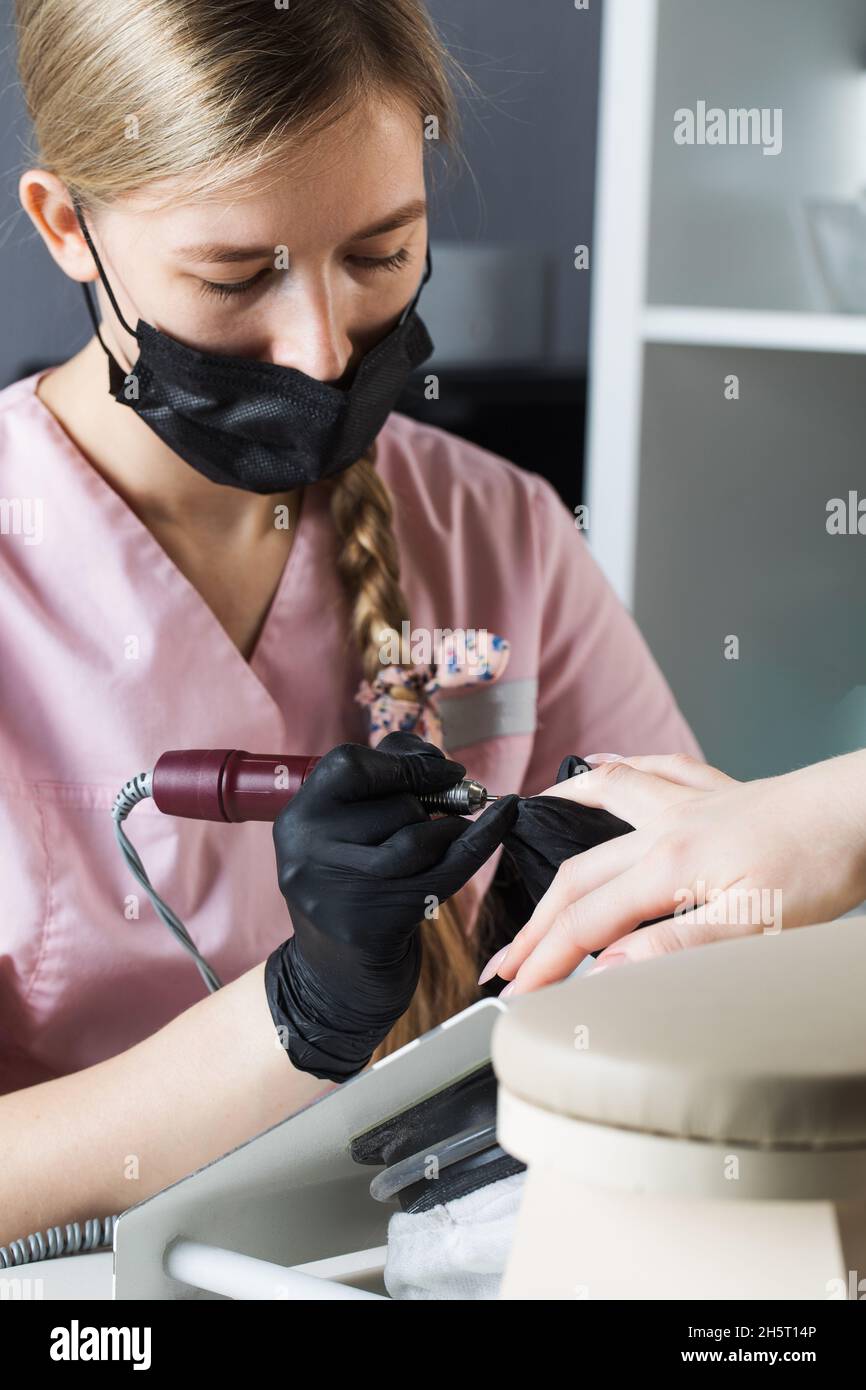 Hardware manicure. Manicure process, cuticle removal with a cutter ...