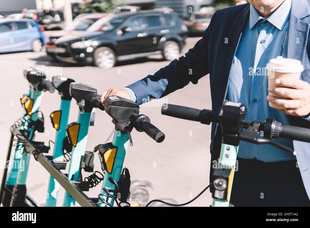 modern man on an electric scooter in the city. Walk and rent eco ...