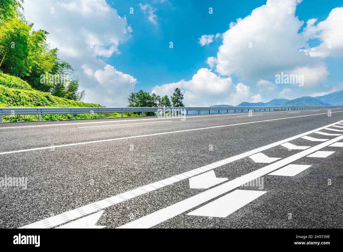 Asphalt road and mountain with tea plantation under blue sky.Road and ...
