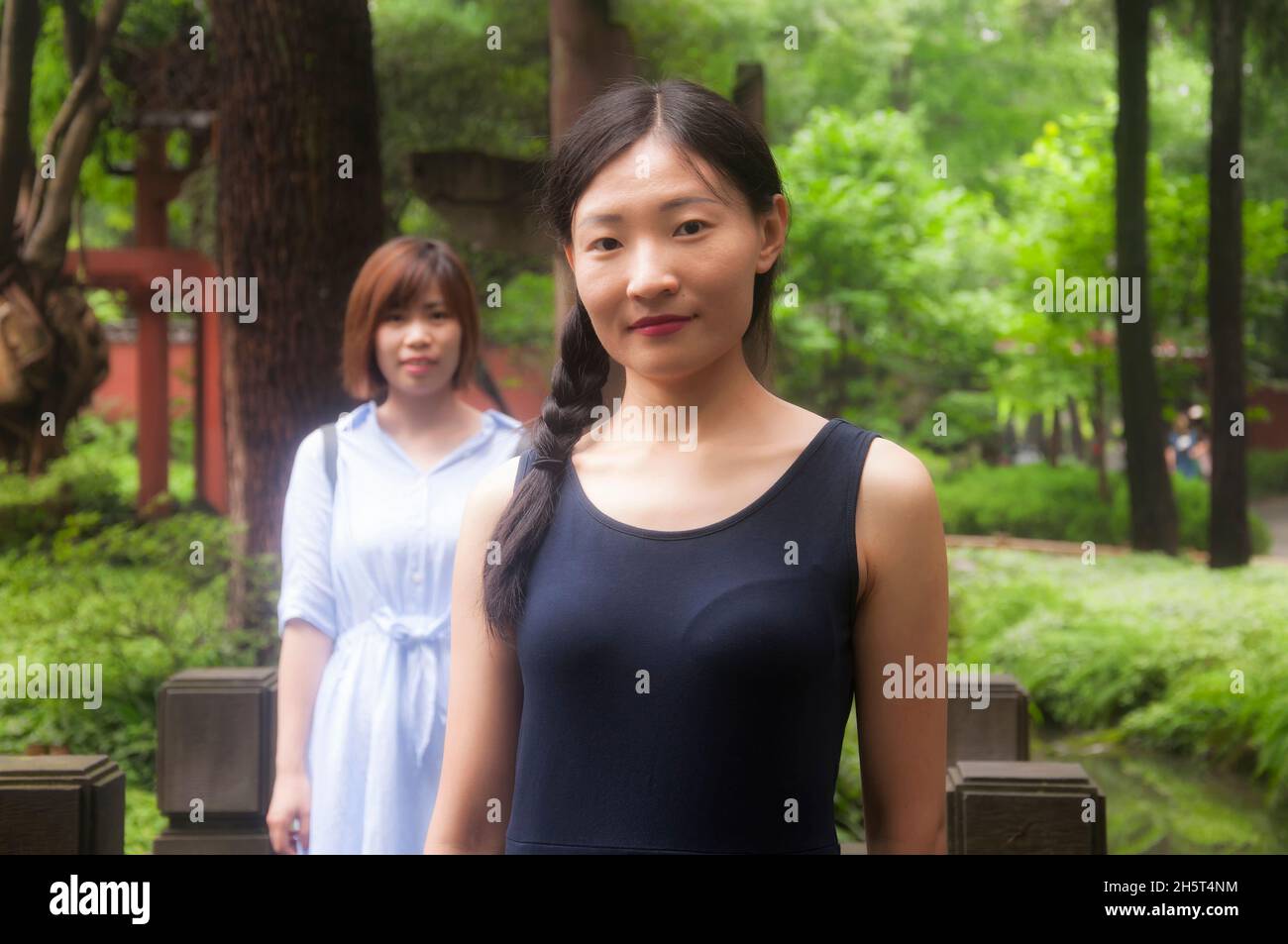 Two happy chinese woman standing in the beautiful gardens within the ...